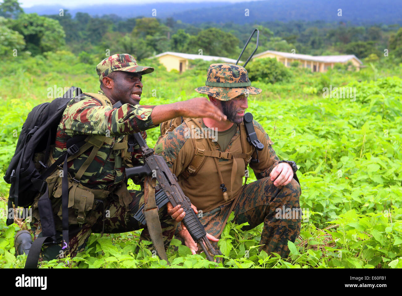 A Cameroonian soldier relays his situation to a US Marine adviser ...