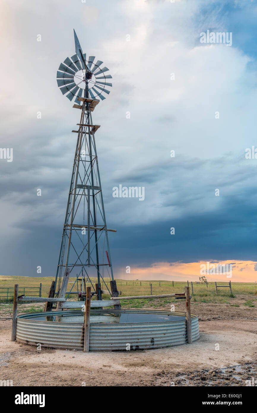 windmill with a pump and cattle water tank in shortgrass prairie ...
