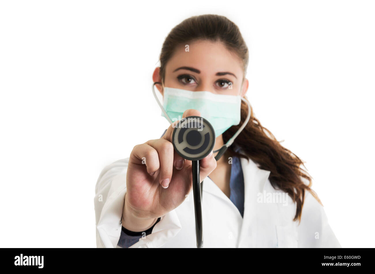 Young pretty female doctor wearing a mask and holding stethoscope Stock ...