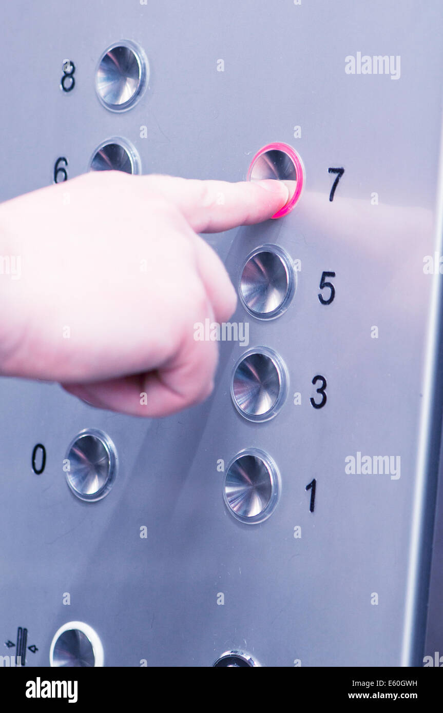 white man pushing buttons on an elevator Stock Photo - Alamy