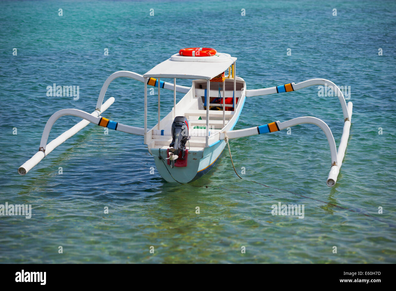 Balinese traditional boat with modern motor - double outrigger jukung ...