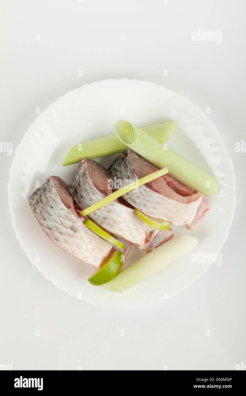Carp fish on white plate with limeta and onion Stock Photo - Alamy