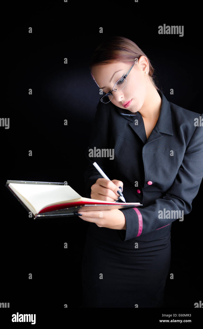 Woman Taking Notes While Talking on Phone Stock Photo - Alamy