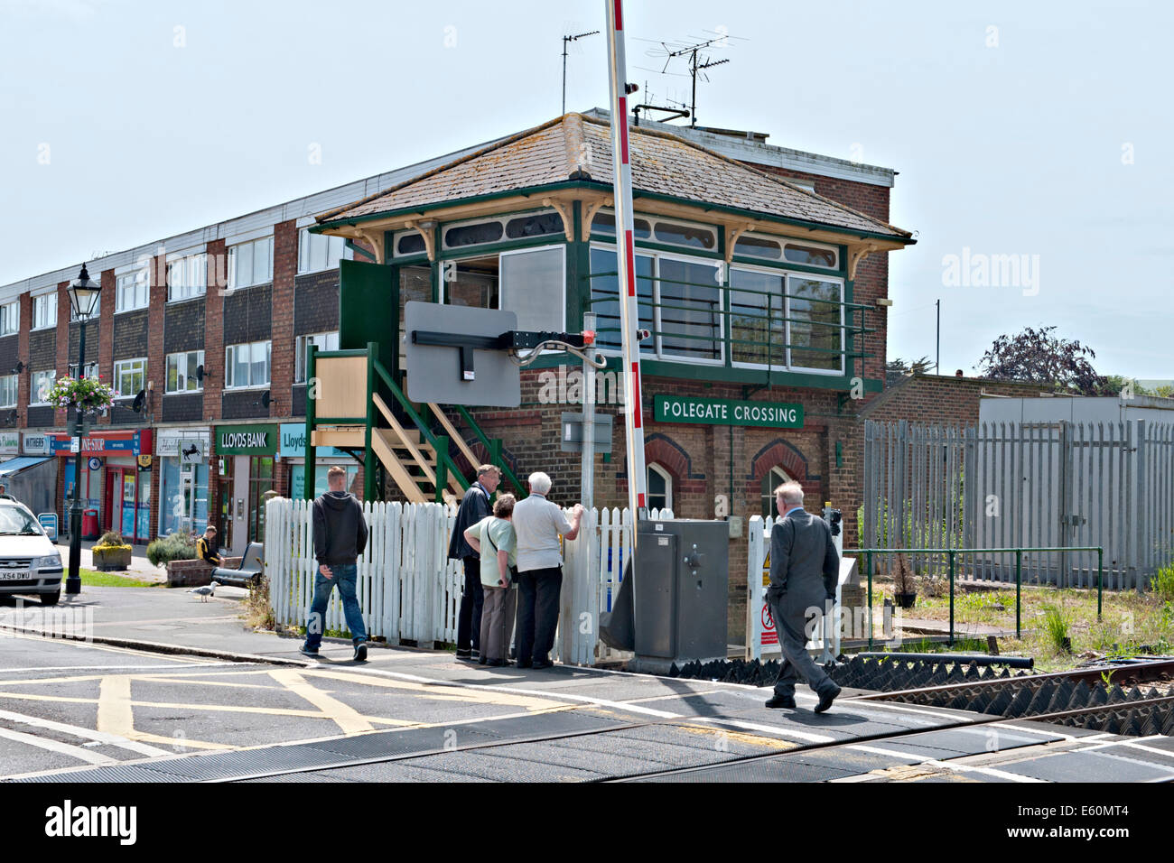 Pedestrians at the railway crossing and signal box at Polegate Sussex ...