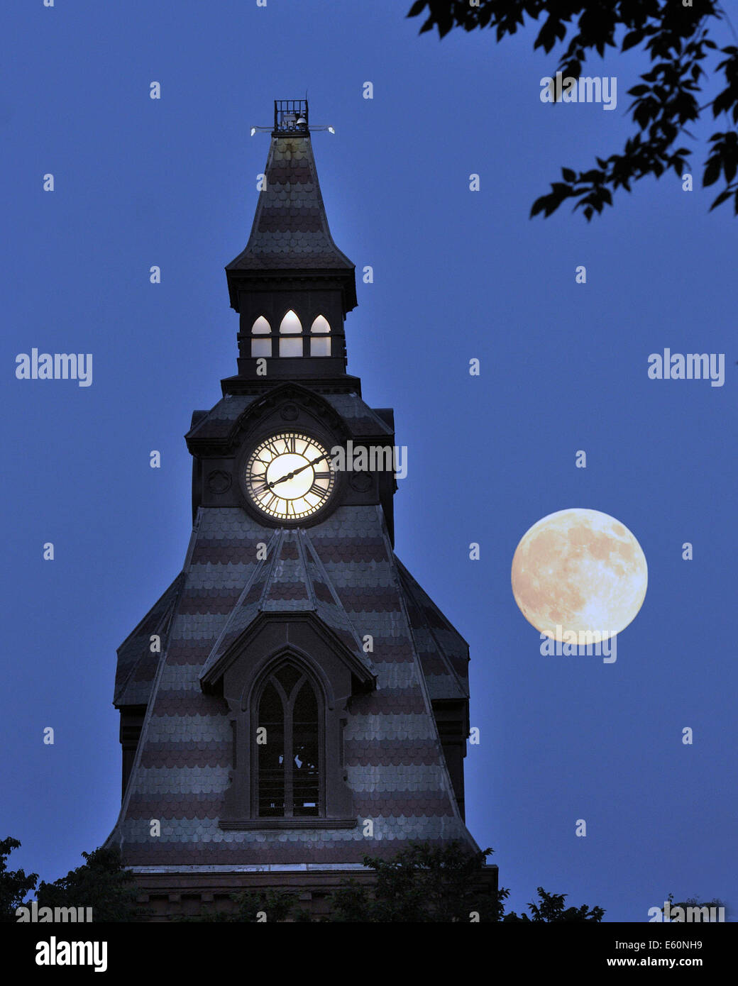 The moon appears over the city hall in New Haven, Connecticut, USA on ...