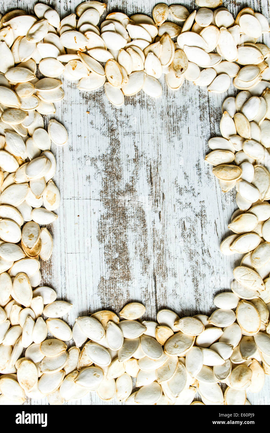 Frame of pumpkin seeds on a wooden table, background Stock Photo - Alamy