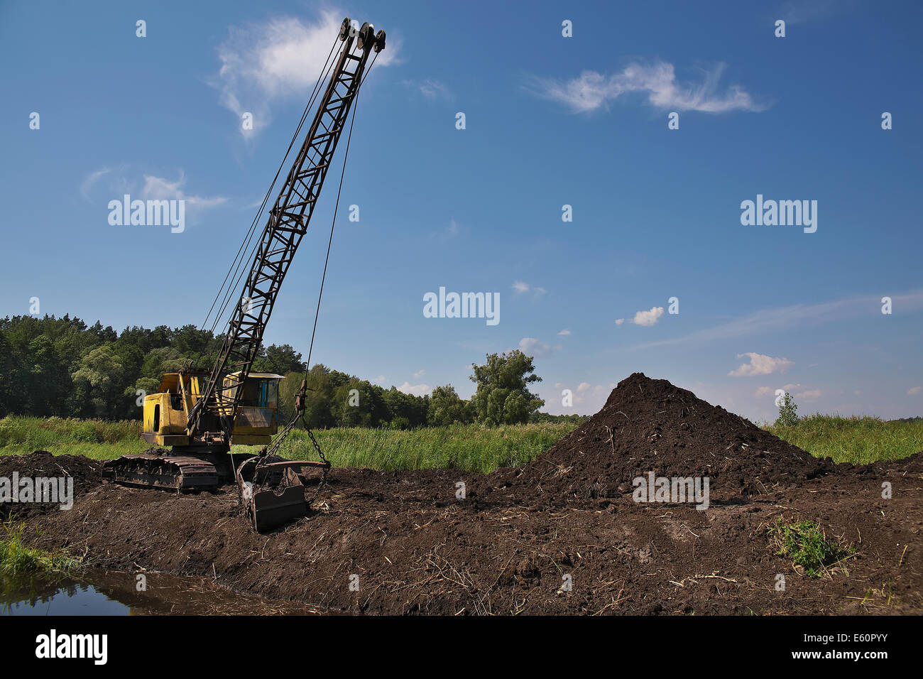 Old dragline (excavator) on the peat quarry in the swamp Stock Photo ...