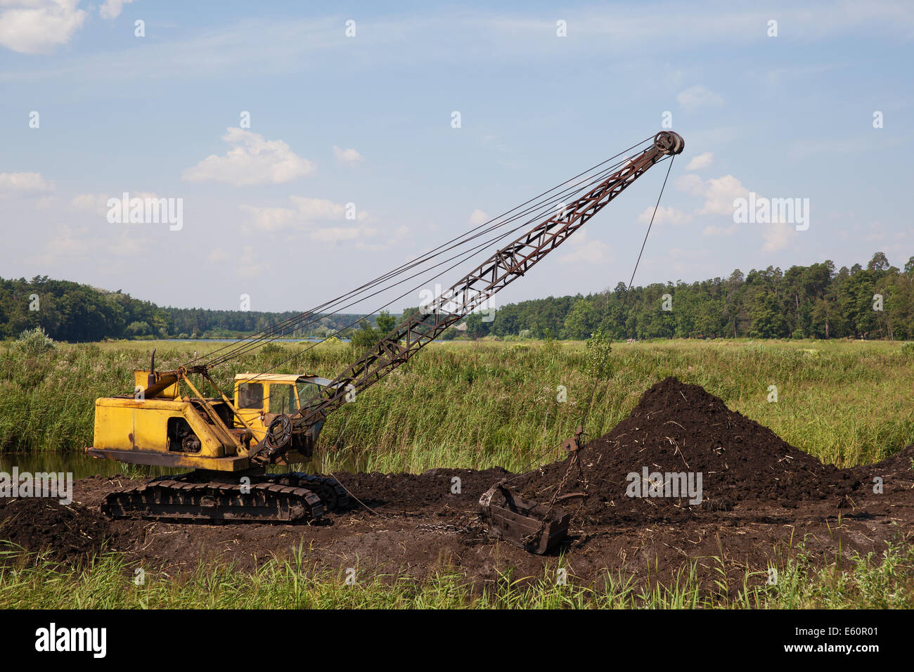 Old dragline (excavator) on the peat quarry in the swamp Stock Photo ...