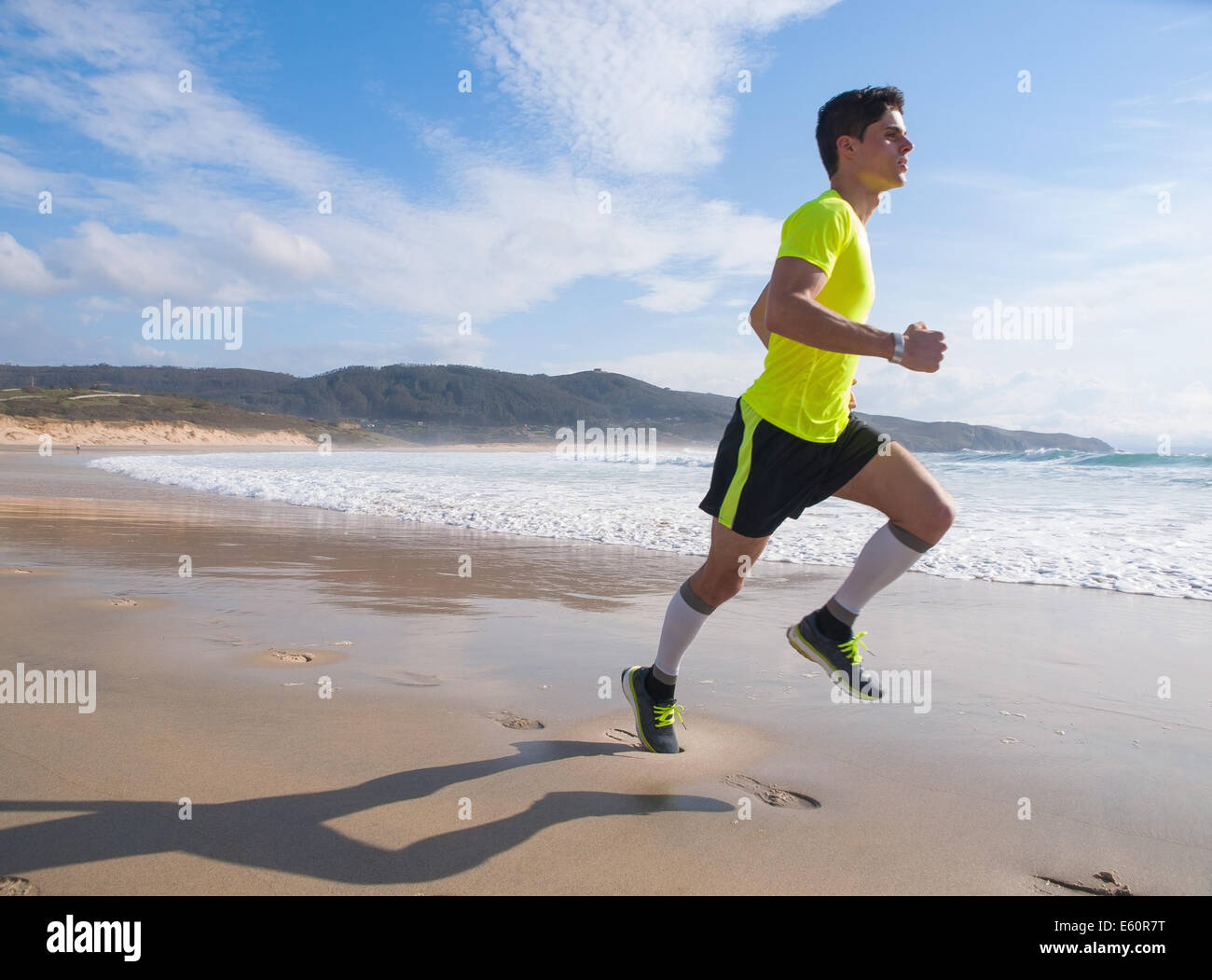 Fit young men jogging along beach hi-res stock photography and images ...