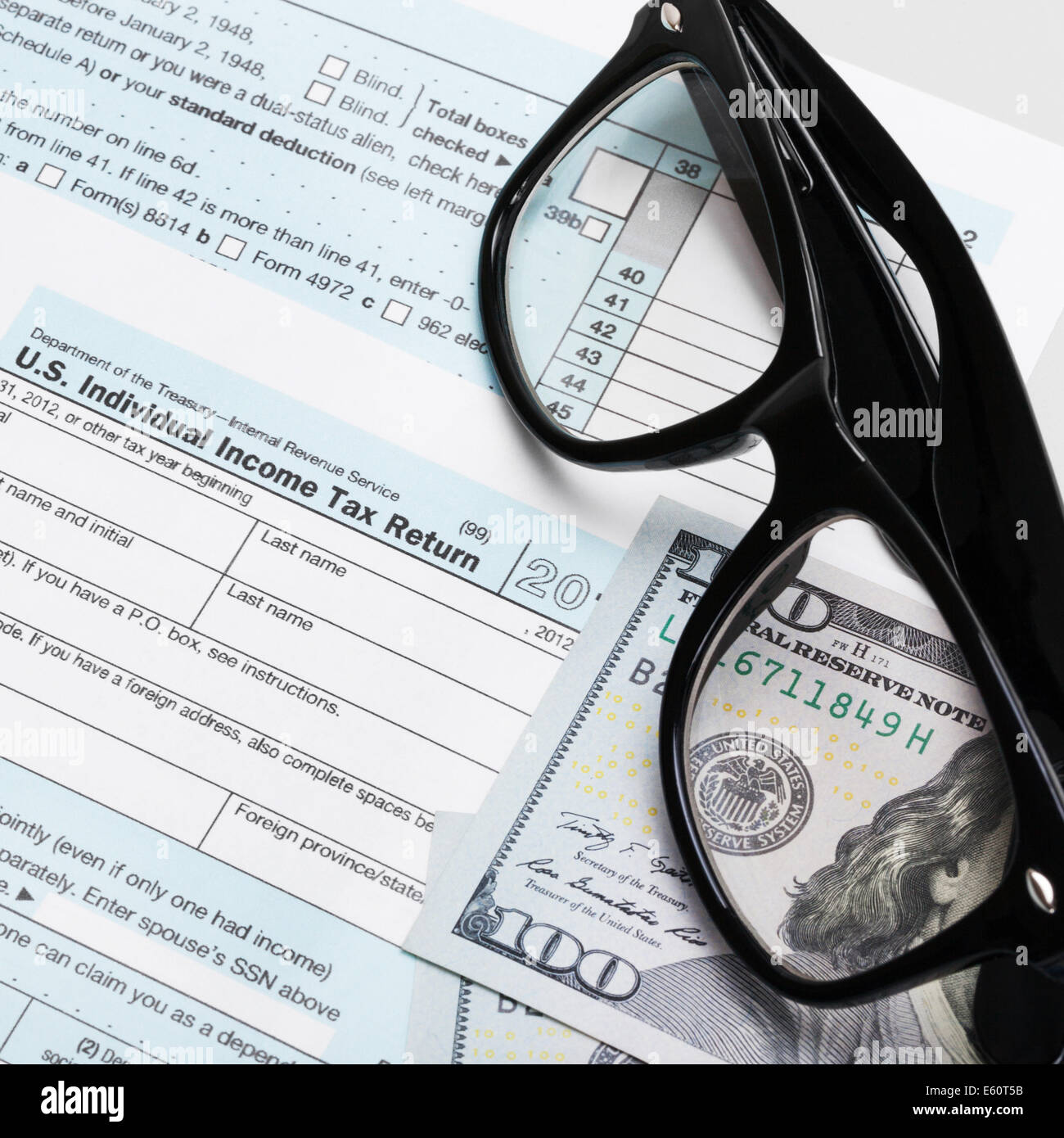 USA Tax Form 1040 with glasses and 100 US dollar bills Stock Photo - Alamy
