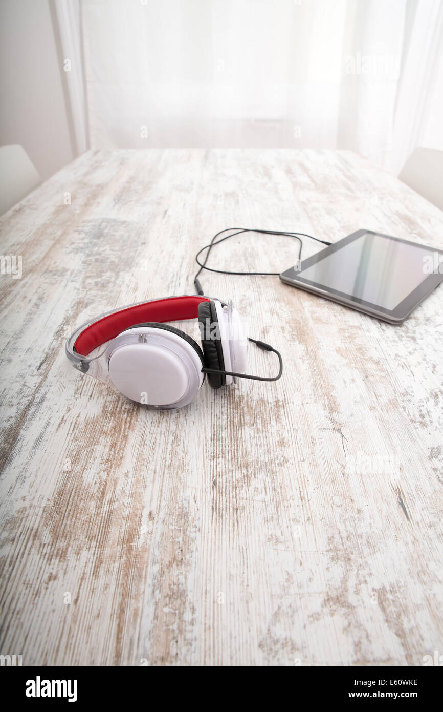 A Tablet PC with headphones on the Table Stock Photo - Alamy