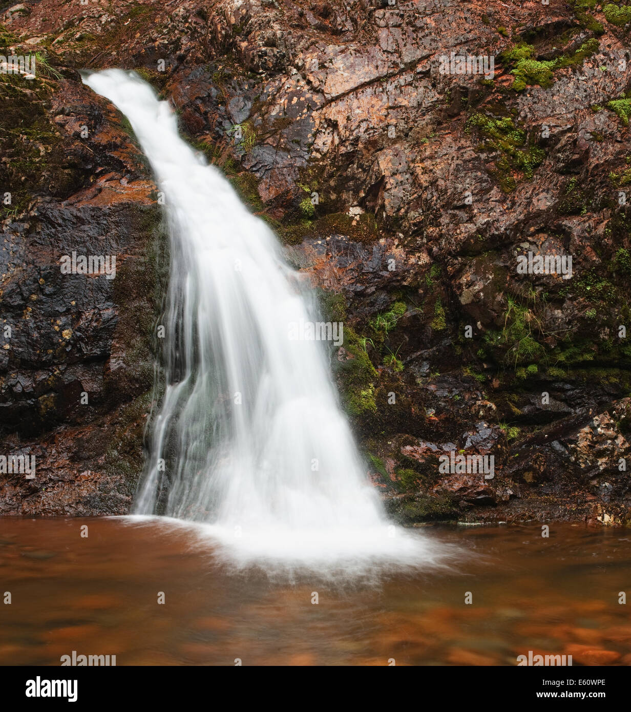 Small waterfall on rock face Stock Photo - Alamy