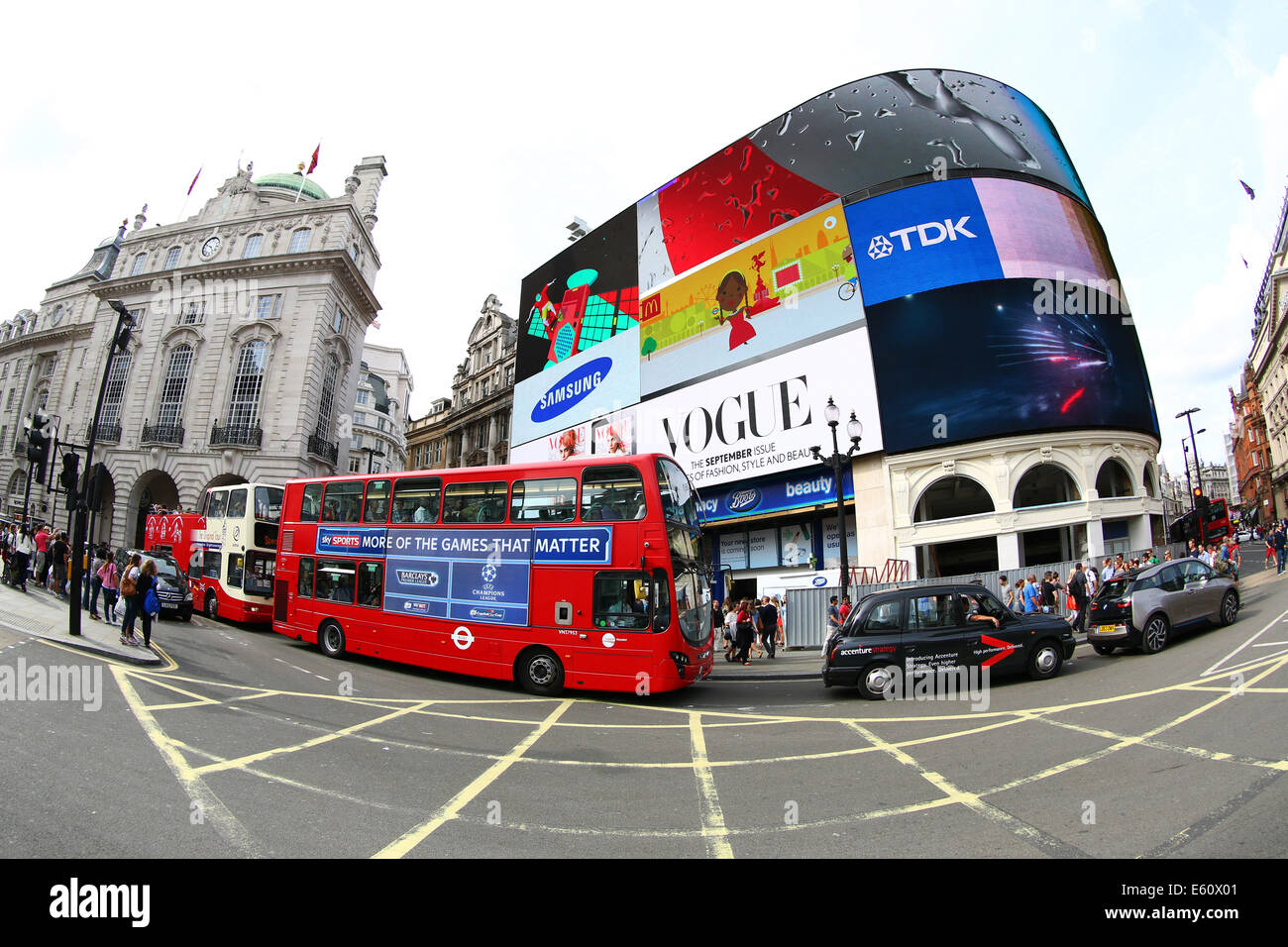 Red London buses and traffic at Piccadilly Circus in London, England ...