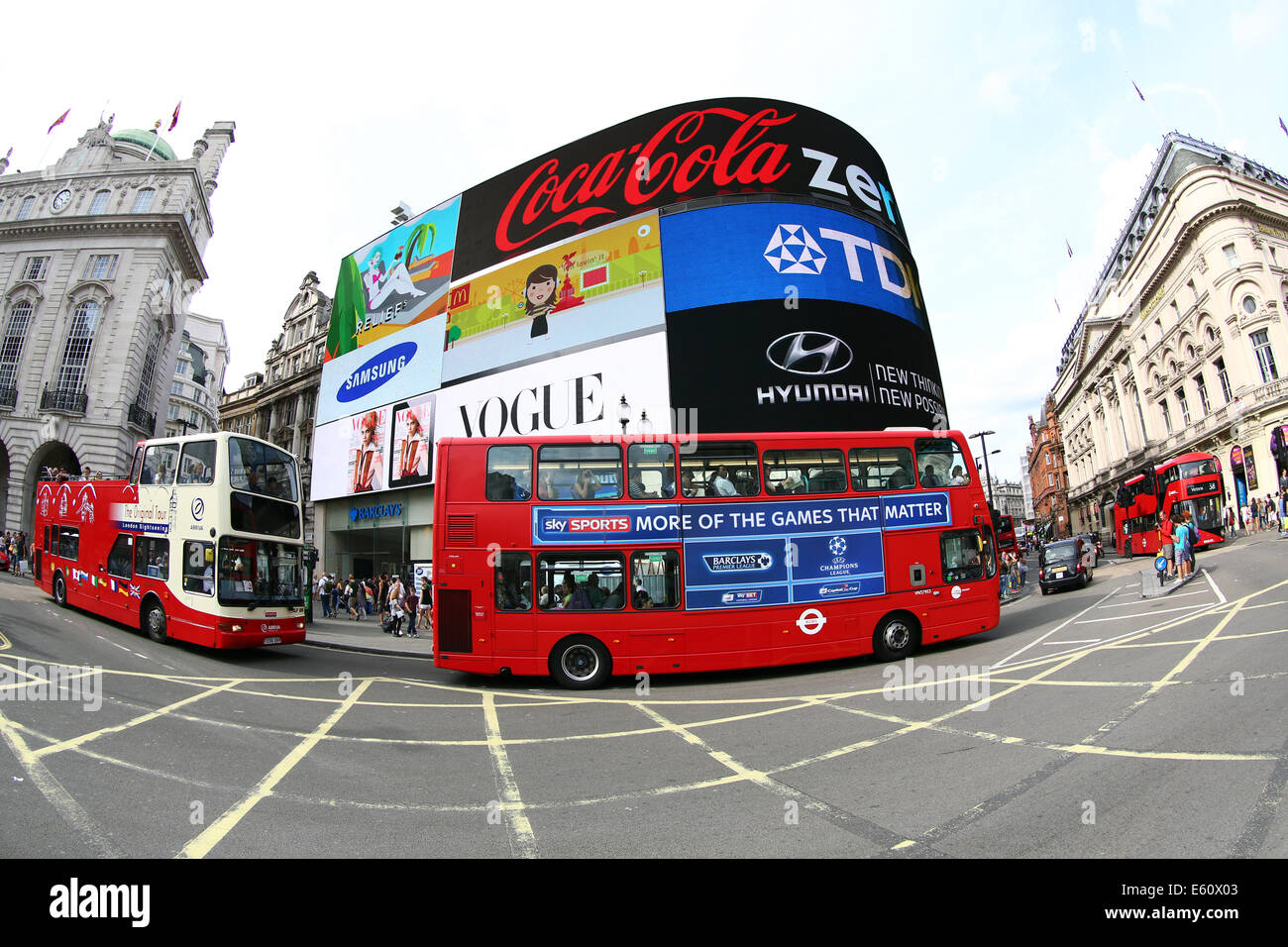 Red London buses and traffic at Piccadilly Circus in London, England ...