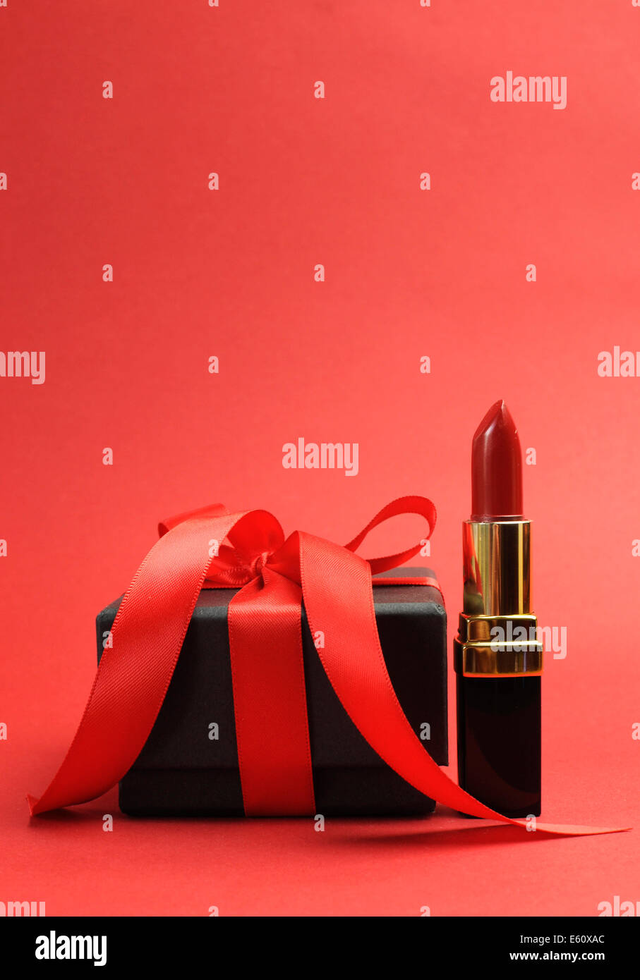 Beautiful luxury red lipstick with black box gift against a red ...