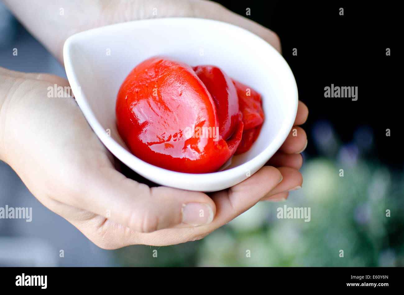 Hands holding organic red peppers in a ceramic pot Stock Photo - Alamy