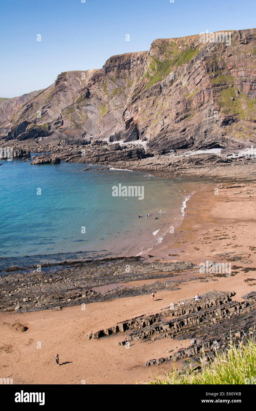 People enjoy Hartland beach in the summer with rugged coastline and ...