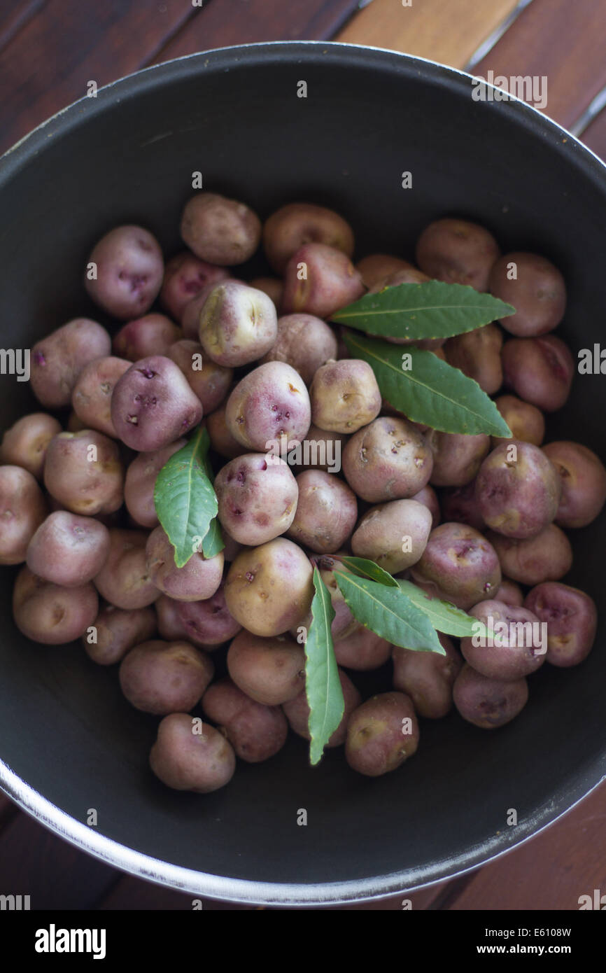 Andean potatoes in a pan over a wooden table Stock Photo - Alamy