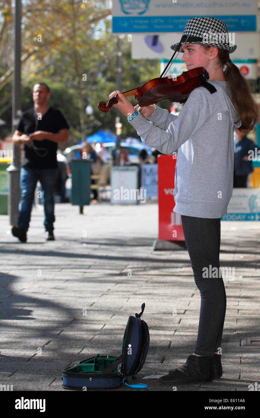 A young girl is busking with her violin in Fremantle, Western Australia ...