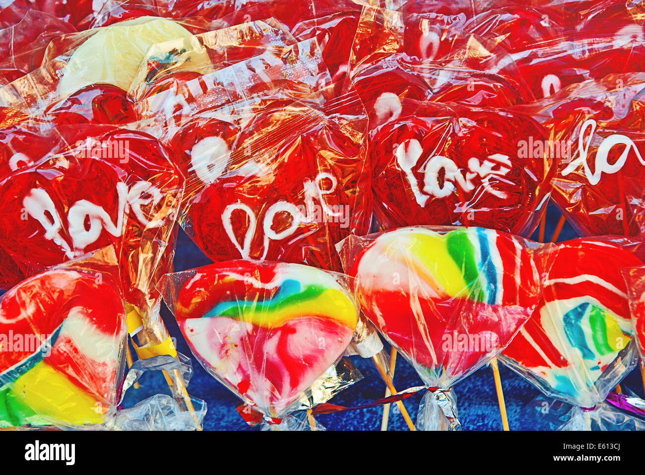 Colorful sweets, candies and lollipops with word love at street market ...