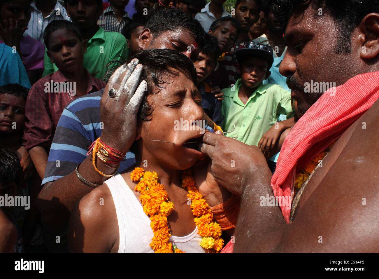 South Indian devotee gets his cheek pierced with a metal rod while ...