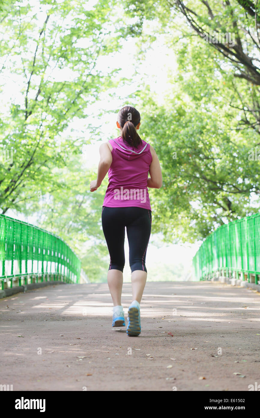 Young Japanese girl running in the park Stock Photo - Alamy