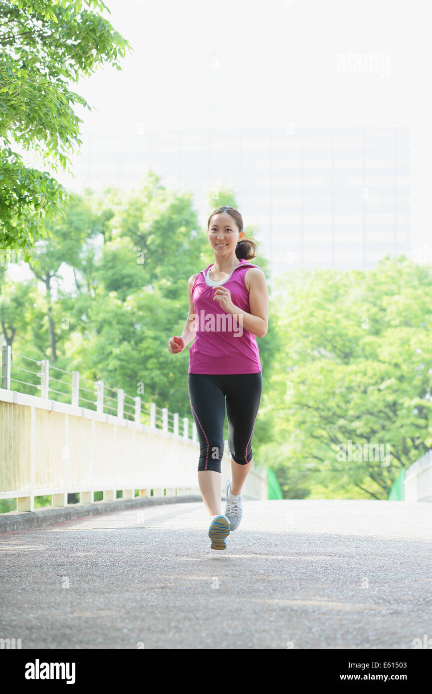 Young Japanese girl running in the park Stock Photo - Alamy