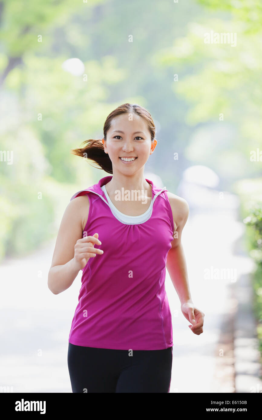 Young Japanese girl running in the park Stock Photo - Alamy