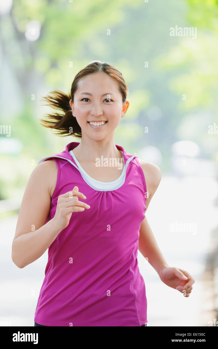 Young Japanese girl running in the park Stock Photo - Alamy