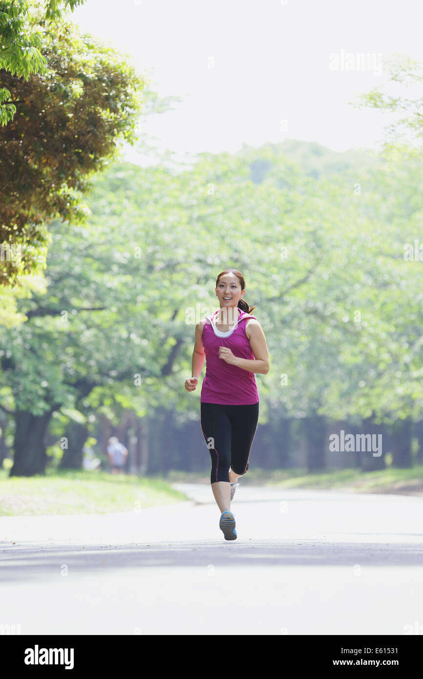 Young Japanese girl running in the park Stock Photo - Alamy
