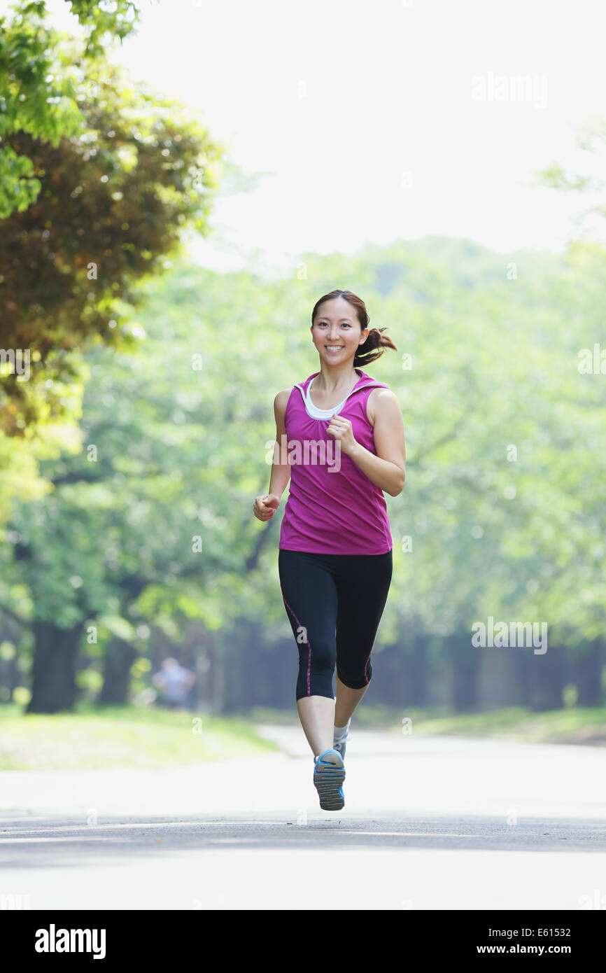 Young Japanese girl running in the park Stock Photo - Alamy