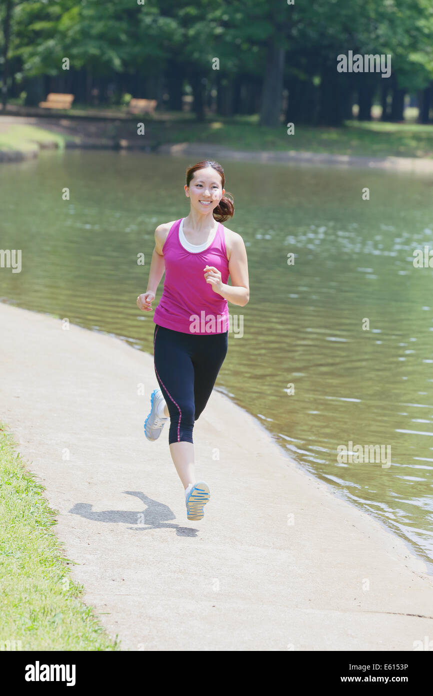 Young Japanese girl running in the park Stock Photo - Alamy