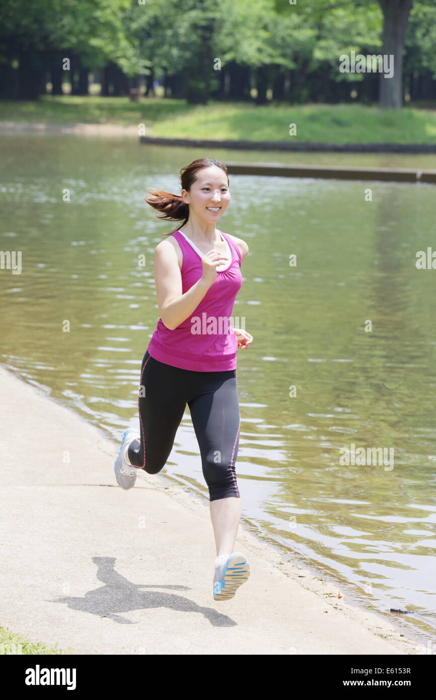 Young Japanese girl running in the park Stock Photo - Alamy