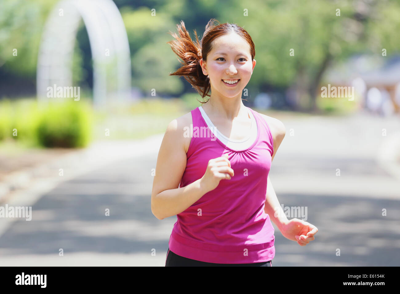 Young Japanese girl running in the park Stock Photo - Alamy