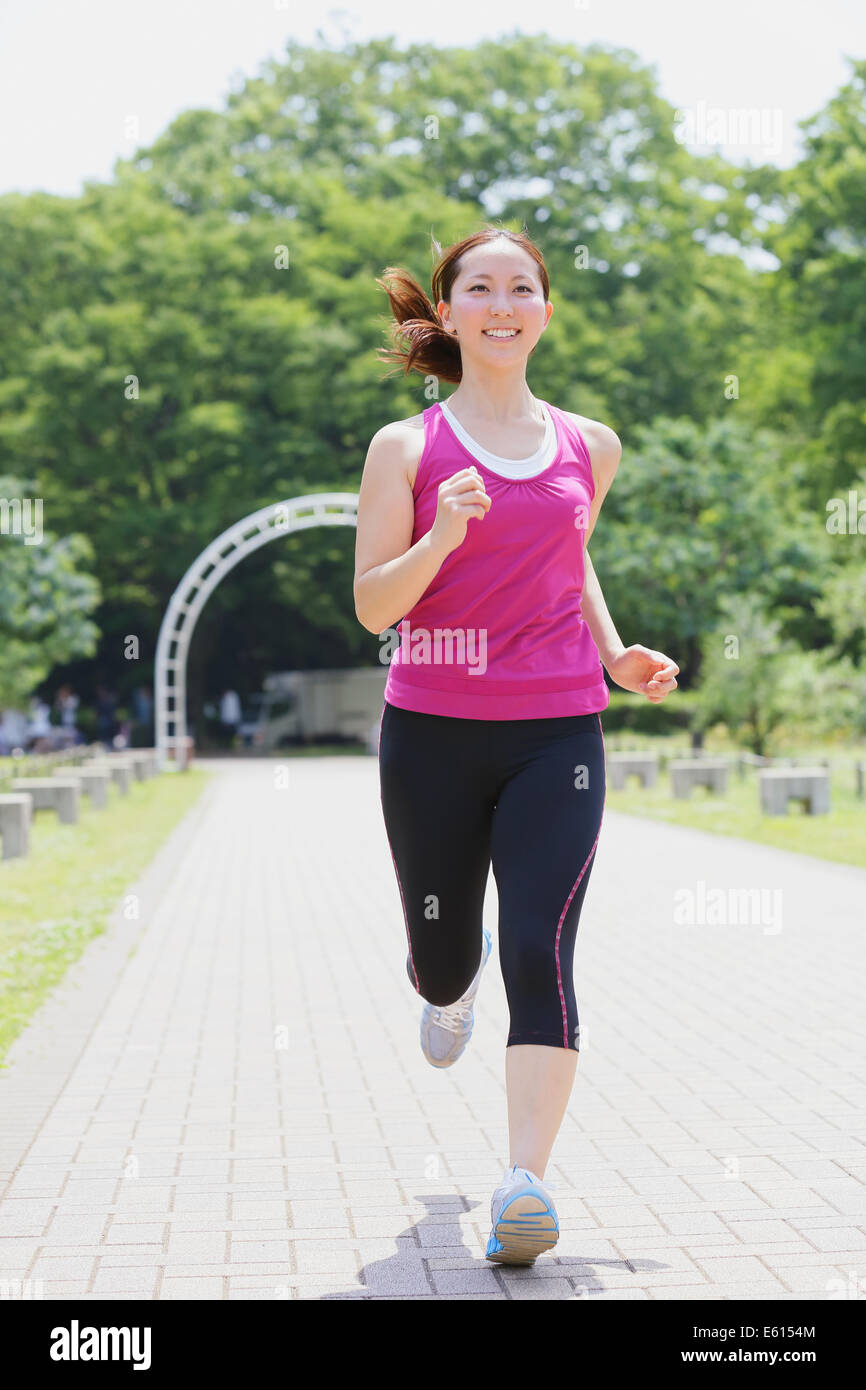Young Japanese girl running in the park Stock Photo - Alamy