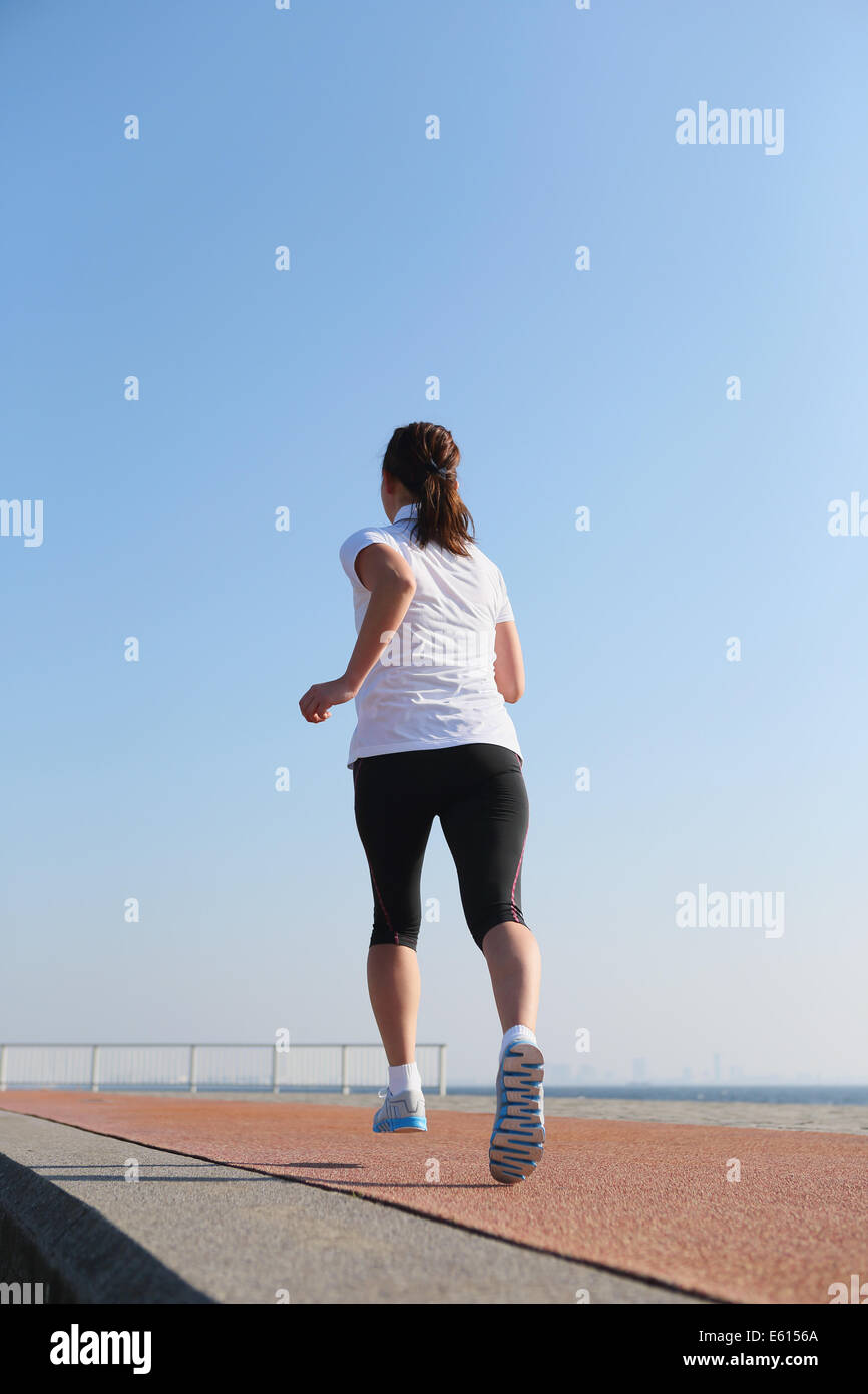 Young Japanese girl jogging Stock Photo - Alamy