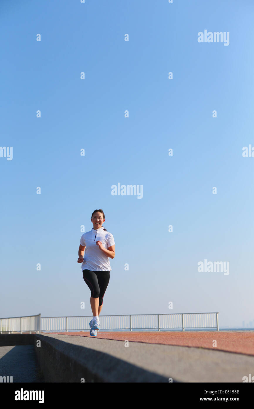 Young Japanese girl jogging Stock Photo - Alamy
