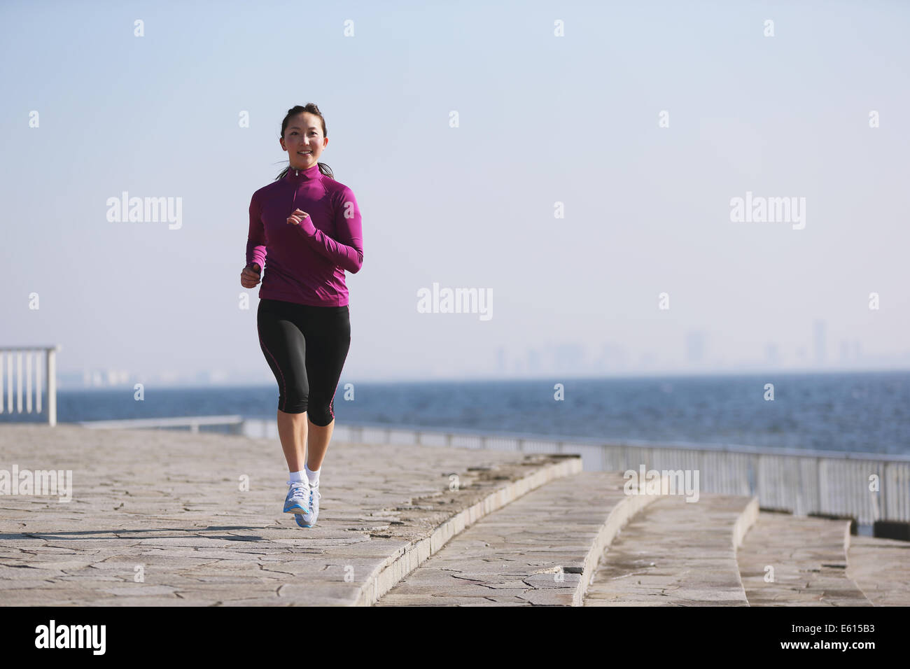 Young Japanese girl jogging Stock Photo - Alamy