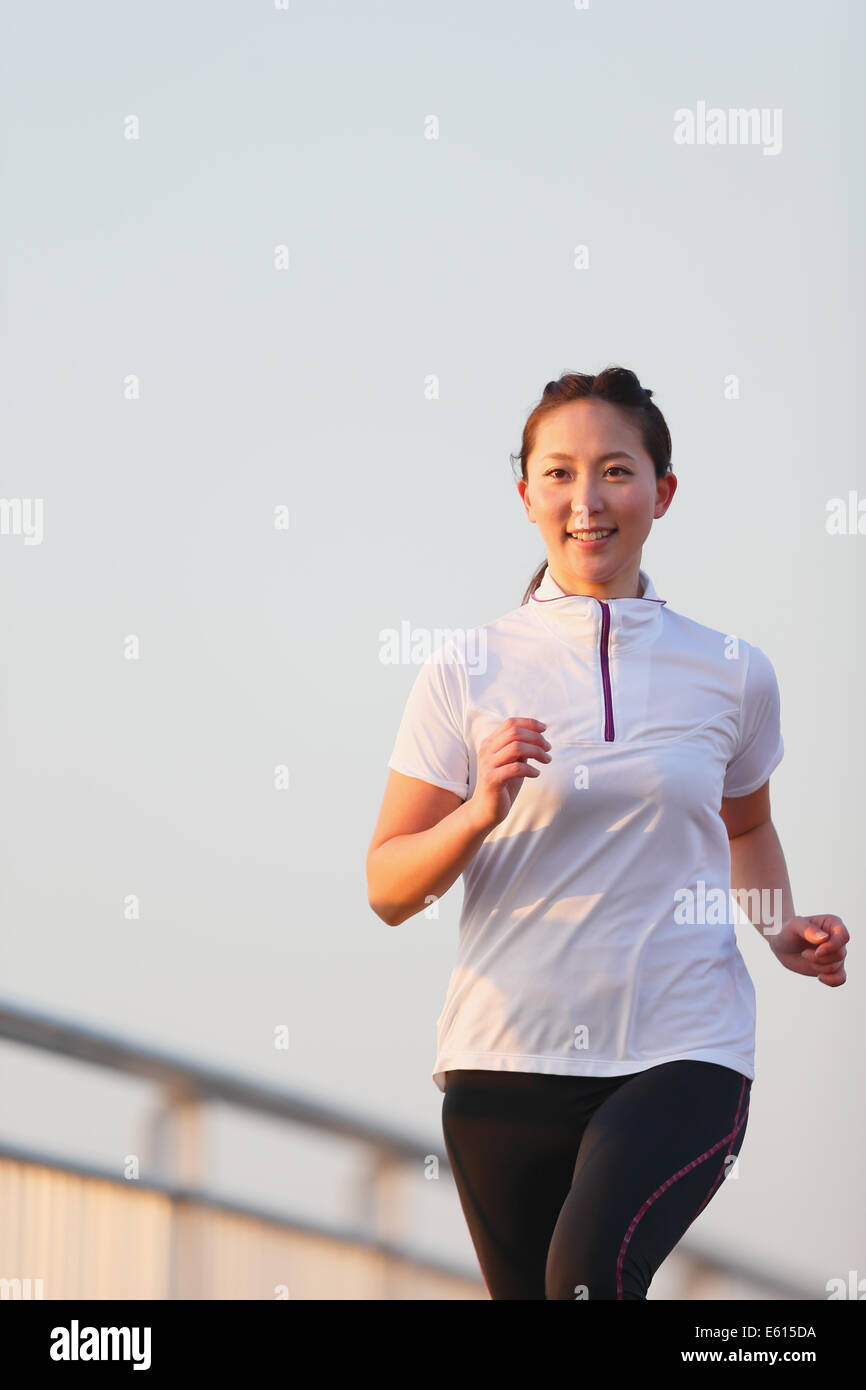 Young Japanese girl jogging Stock Photo - Alamy
