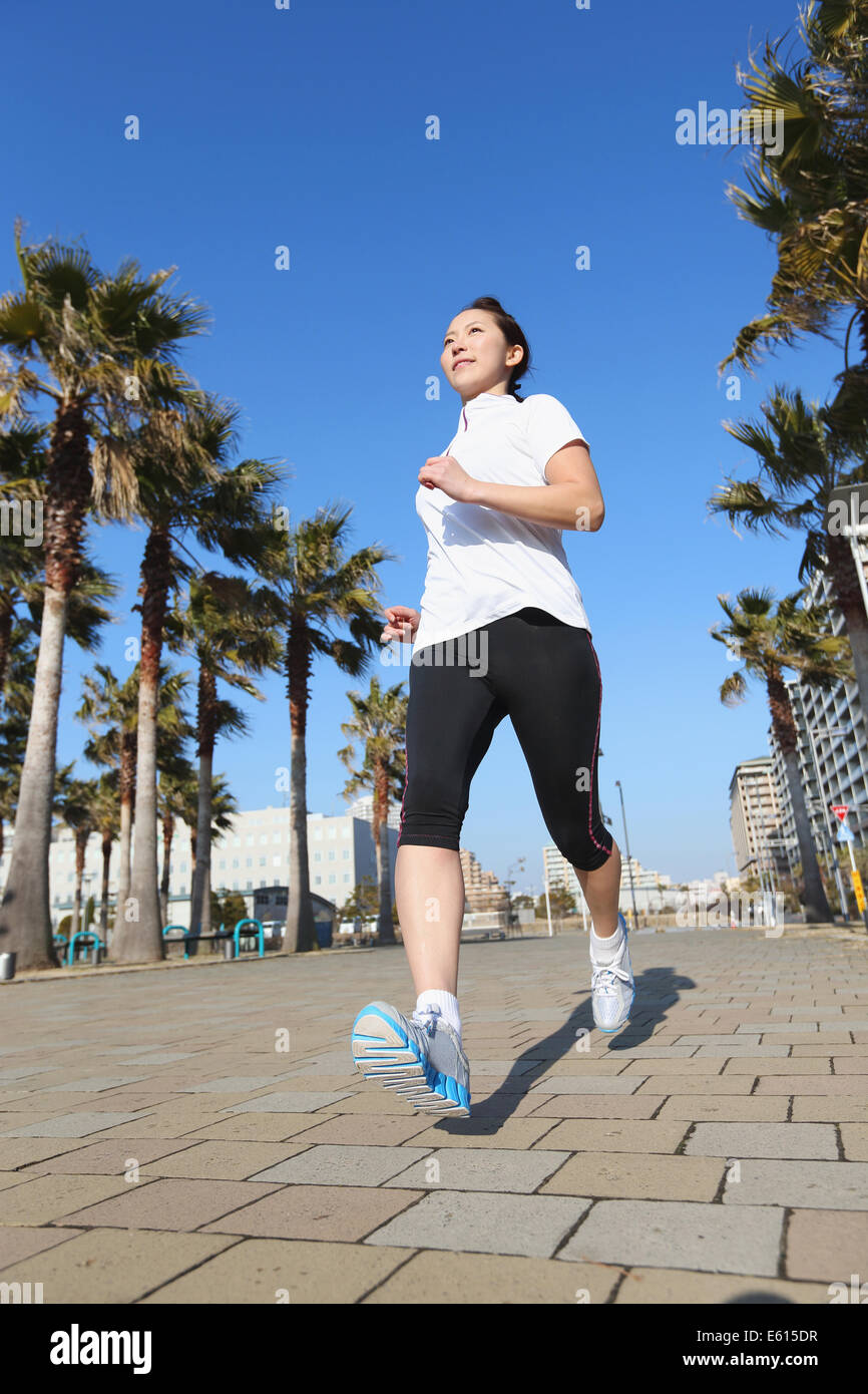 Young Japanese girl jogging Stock Photo - Alamy
