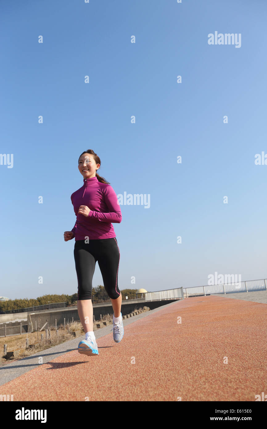 Young Japanese girl jogging Stock Photo - Alamy
