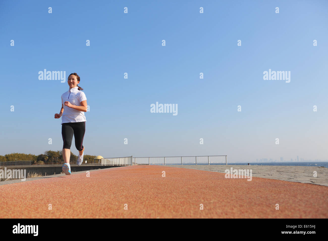 Young Japanese girl jogging Stock Photo - Alamy