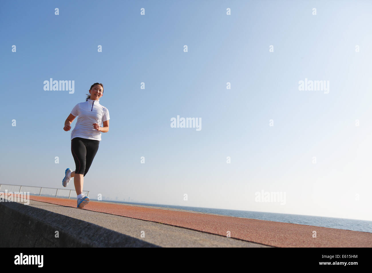 Young Japanese girl jogging Stock Photo - Alamy