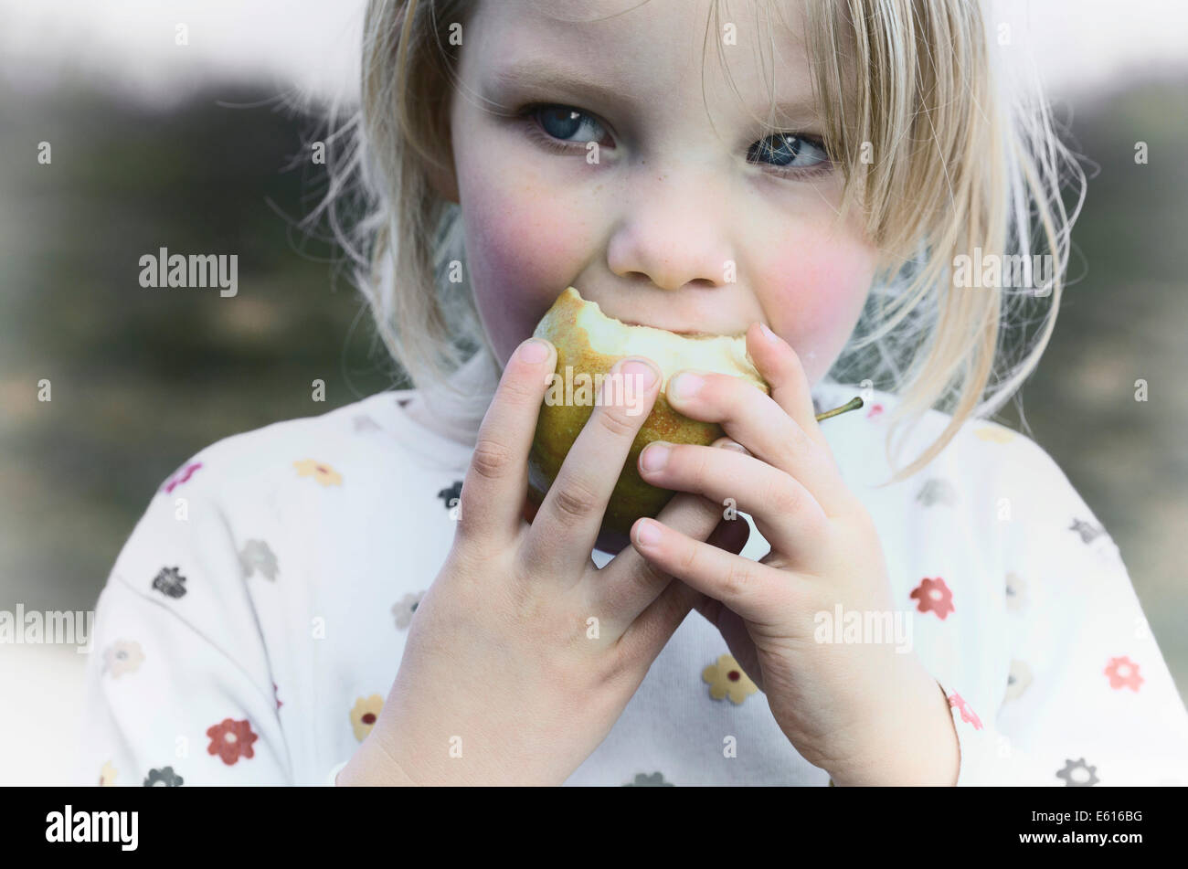 Girl eating an apple Stock Photo - Alamy