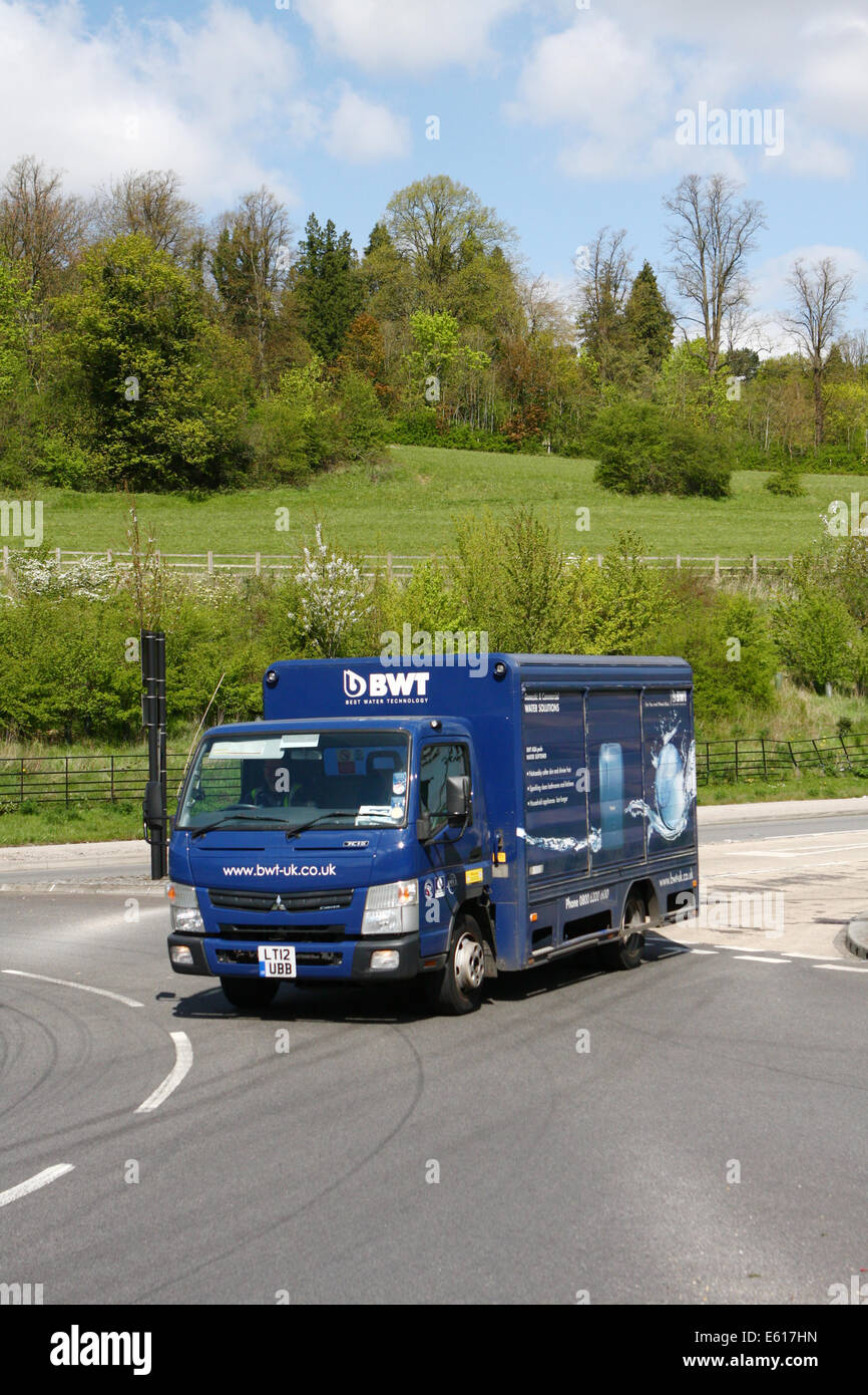 A blue Mitsubishi Canter van entering a roundabout in Coulsdon, Surrey ...