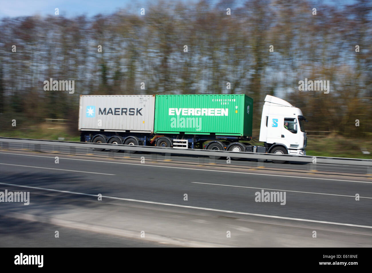An articulated container truck hauling Maersk and Evergreen containers ...