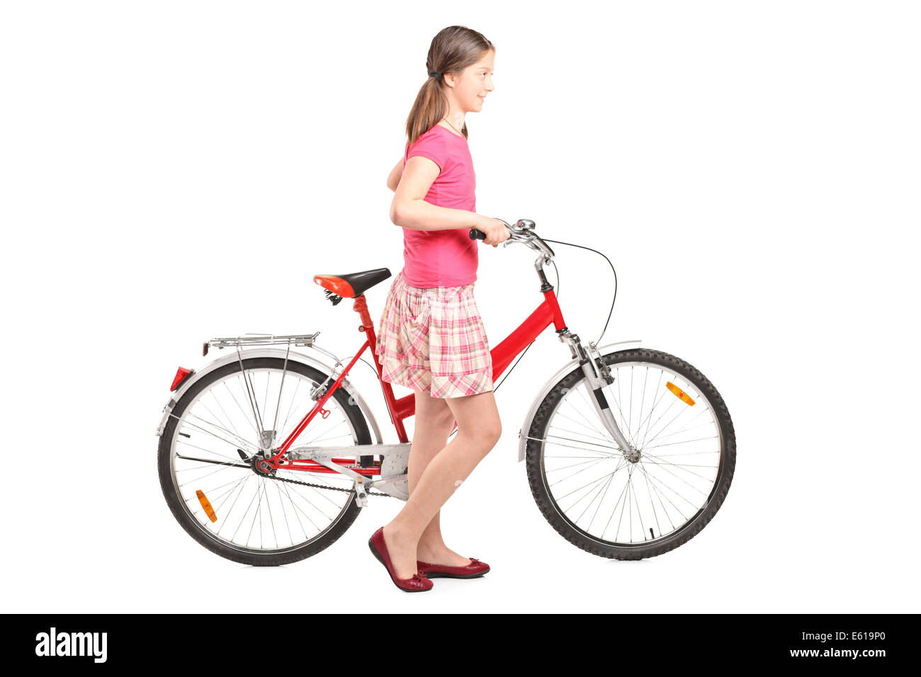 Young girl pushing a bike Stock Photo - Alamy
