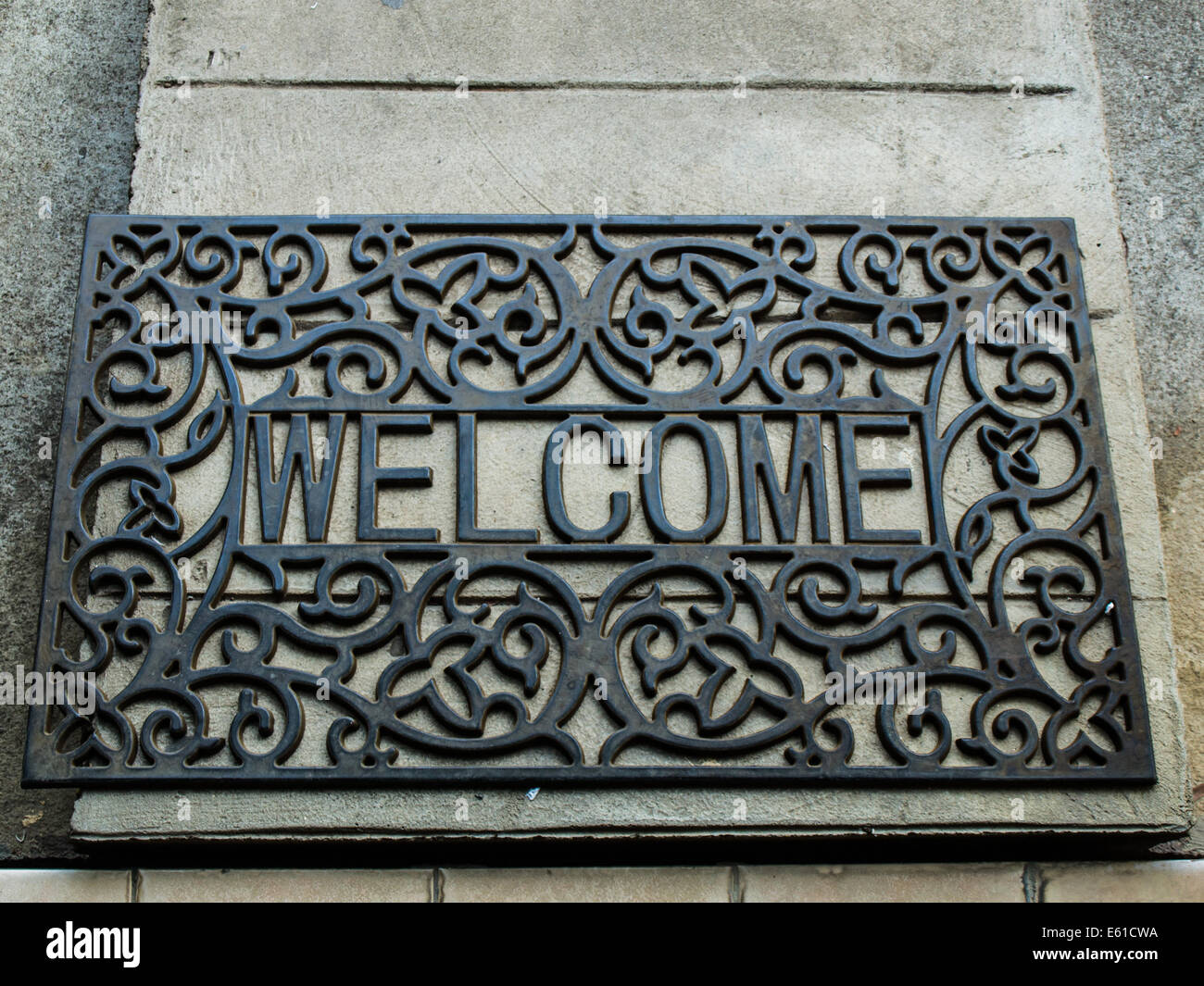 black wrought iron welcome rug in nature Stock Photo - Alamy