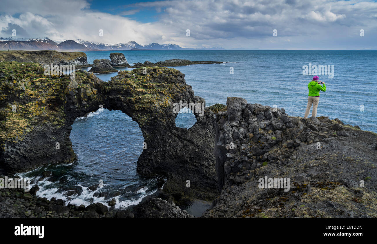 Female taking a picture of the sea while standing on the cliffs at ...