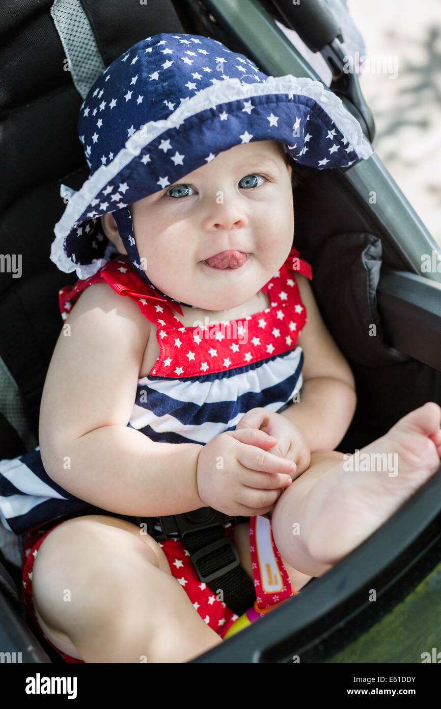 Cute baby girl sitting in her stroller Stock Photo - Alamy